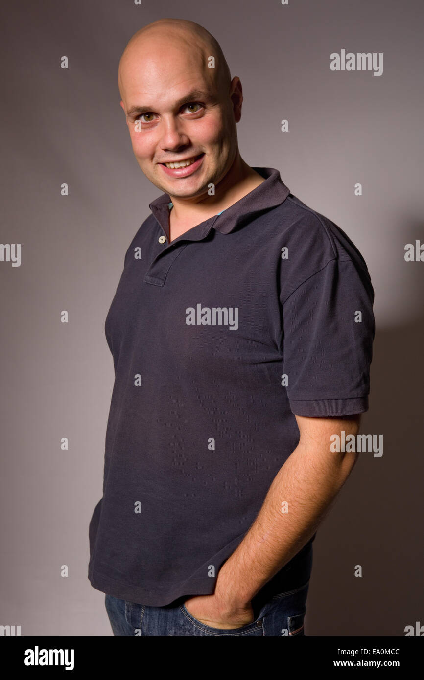 Portrait of young silly man on a dark background Stock Photo - Alamy