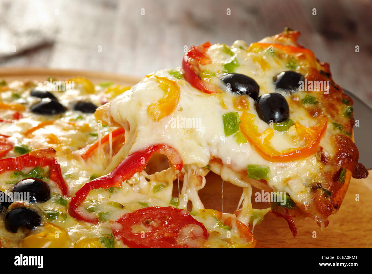 taking slice of pizza,melted cheese dripping Stock Photo - Alamy