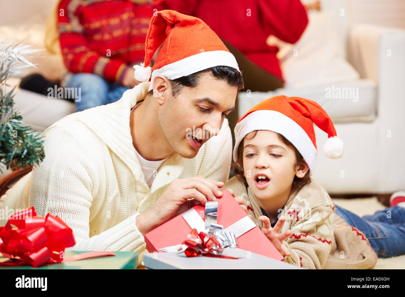 Father and son opening gifts together at christmas eve Stock Photo - Alamy