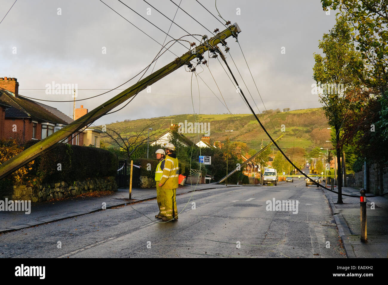 Engineers examine a fallen electricity poles following severe winds ...