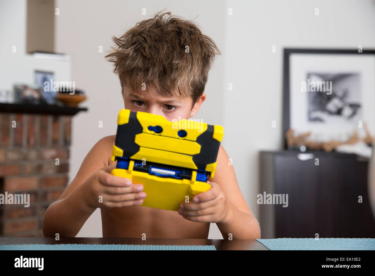 Boy playing with portable game console Stock Photo - Alamy