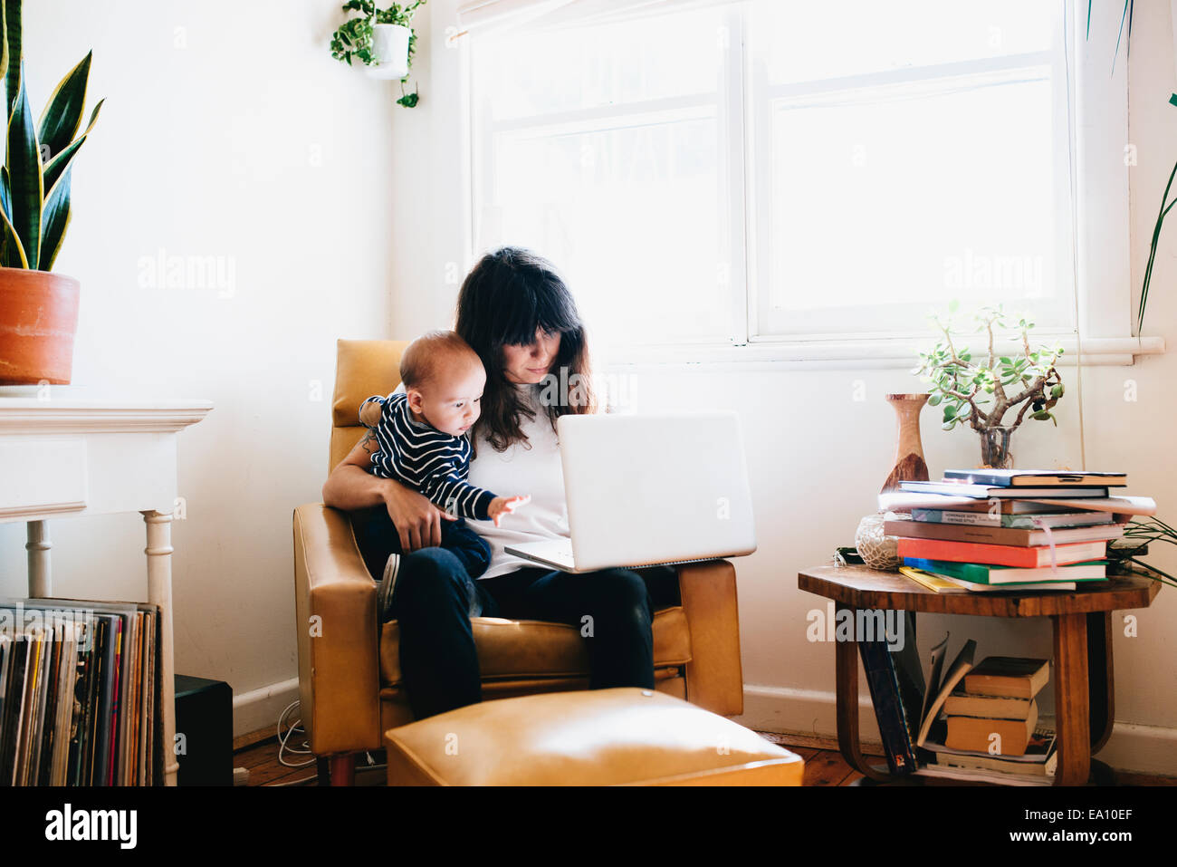 Mother using laptop with son on lap Stock Photo - Alamy