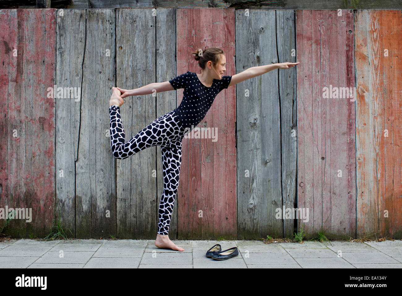 Teenage girl standing on one leg Stock Photo - Alamy