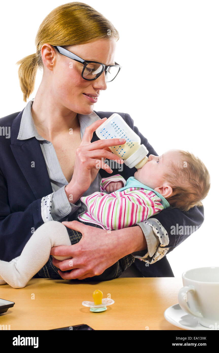 Woman gives baby the bottle Stock Photo - Alamy