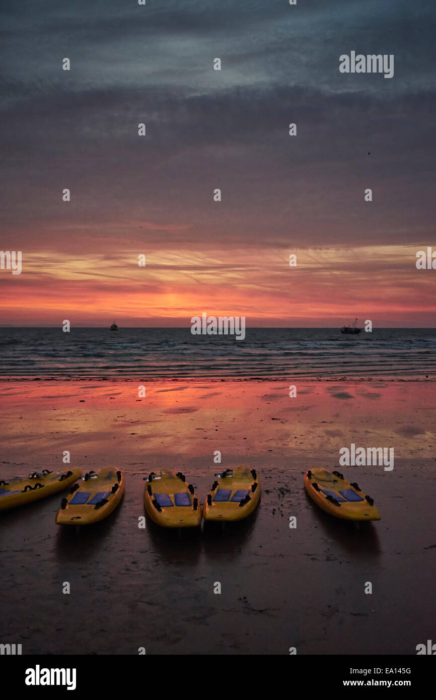 Five sea rescue stretchers on beach at sunrise, Tenby, Wales, UK Stock ...