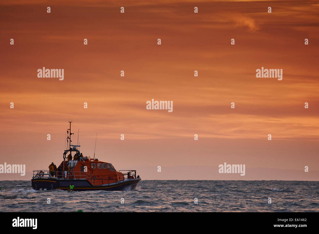 Lifeboat at sea at sunrise, Tenby, Wales, UK Stock Photo - Alamy