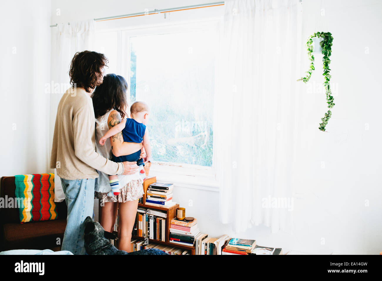 Family looking out of window Stock Photo - Alamy