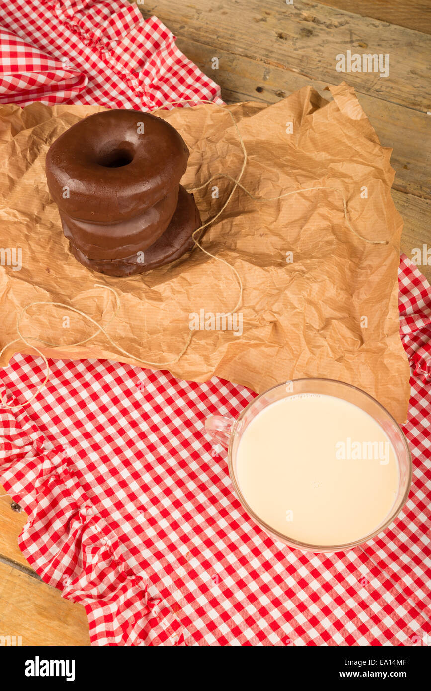 Pile of chocolate donuts served with a glass of hot milk Stock Photo ...