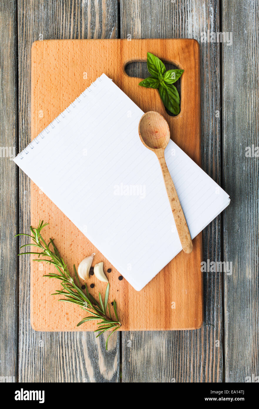 Recipe concept. Blank sheet of paper on a wooden board with spices ...