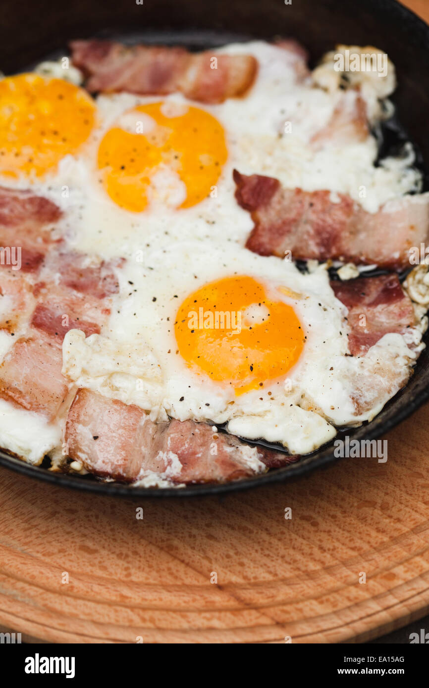 Fried bacon and eggs on the pan - rusty breakfast Stock Photo - Alamy