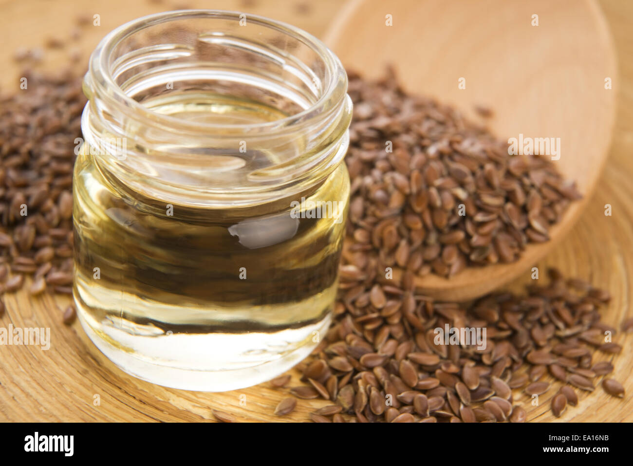 Linseed oil and flax seeds on wooden background Stock Photo - Alamy