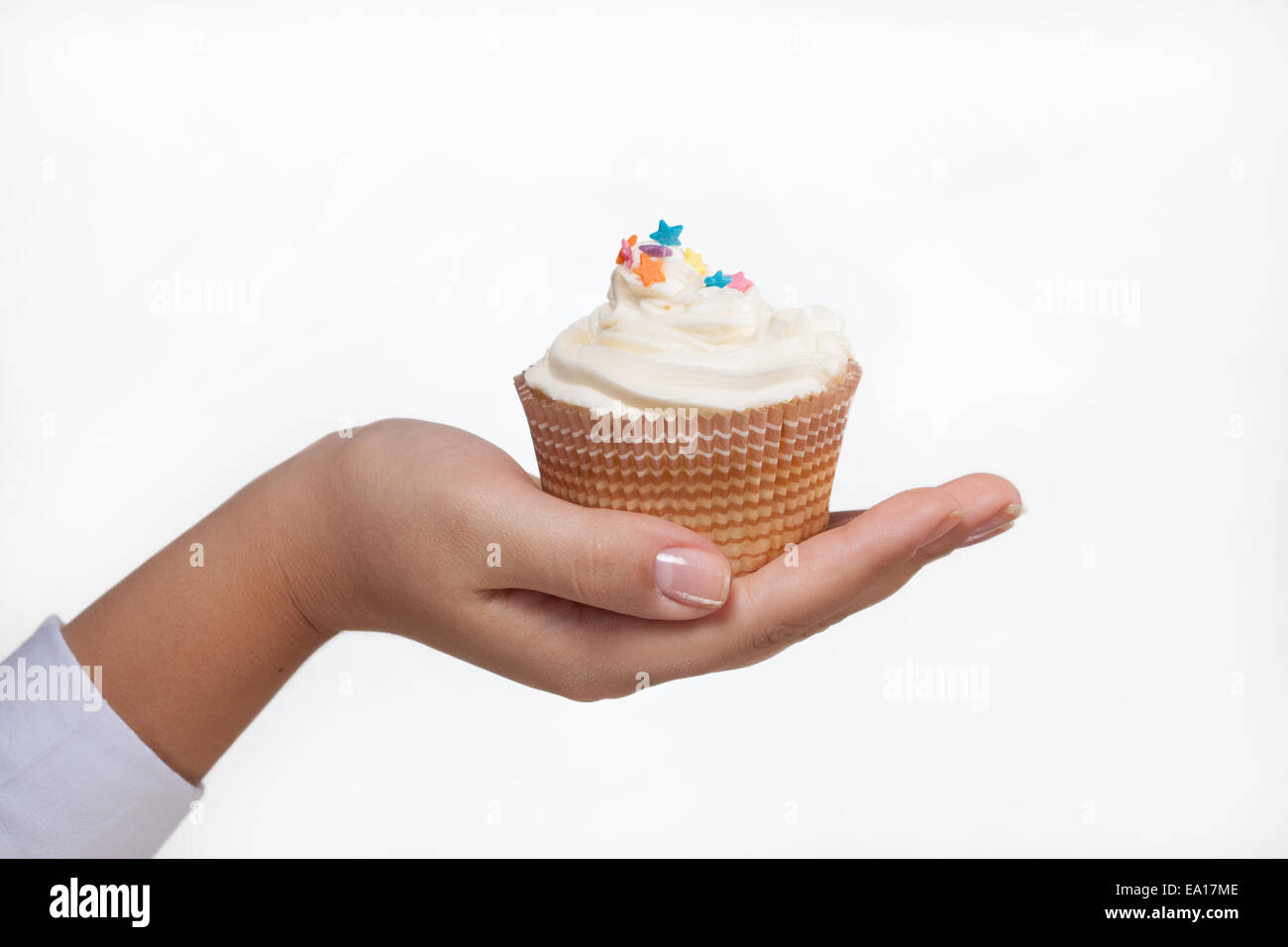 hand holding a cupcake isolated on white Stock Photo - Alamy