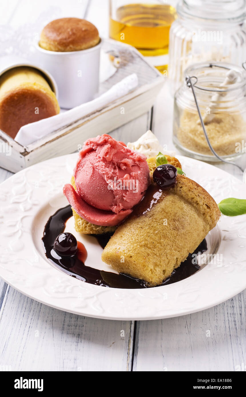 Rum baba with ice cream Stock Photo - Alamy