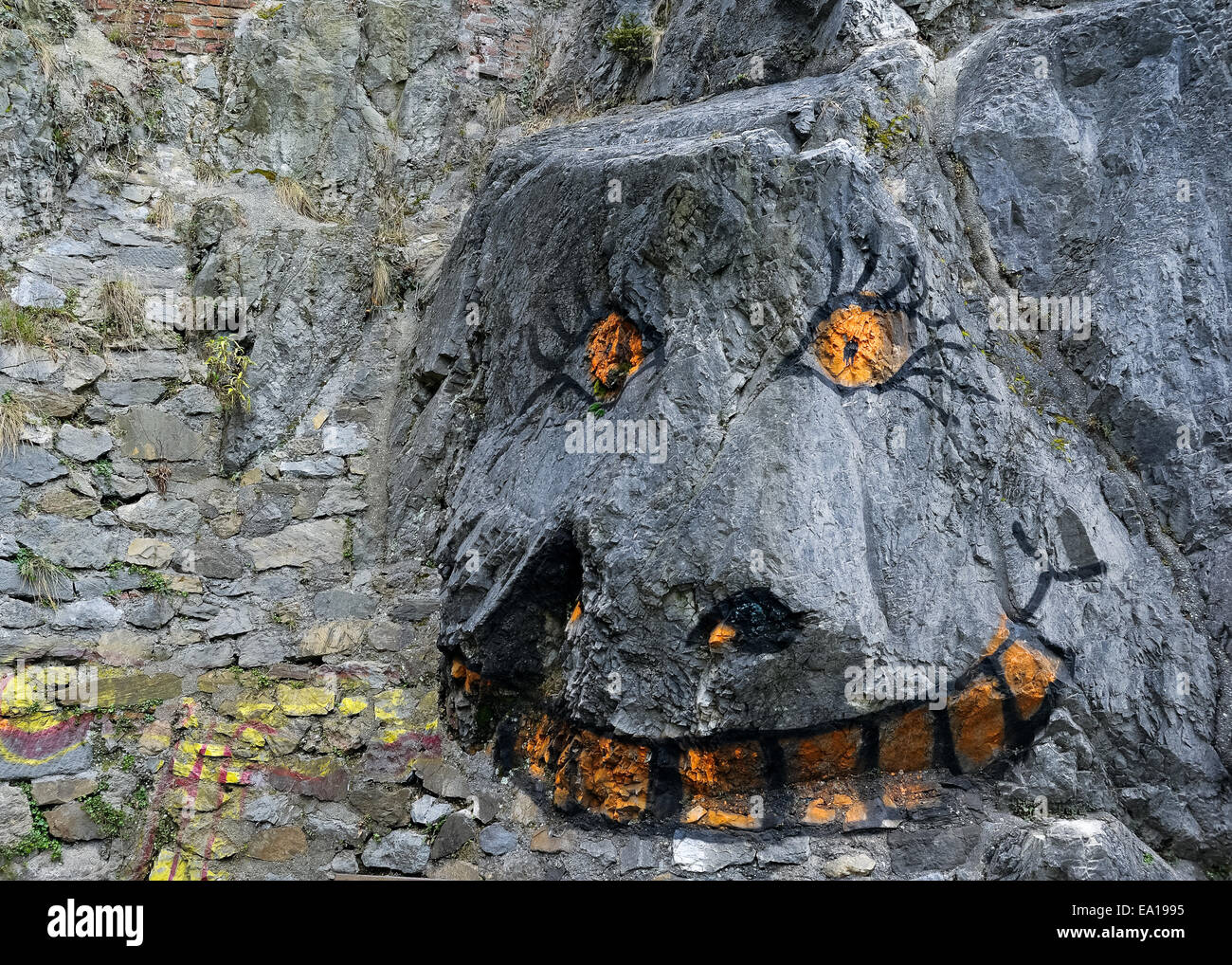 Monster face grafitti on boulder Stock Photo - Alamy