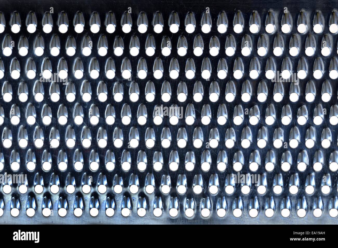A close up shot of a metal grater Stock Photo - Alamy