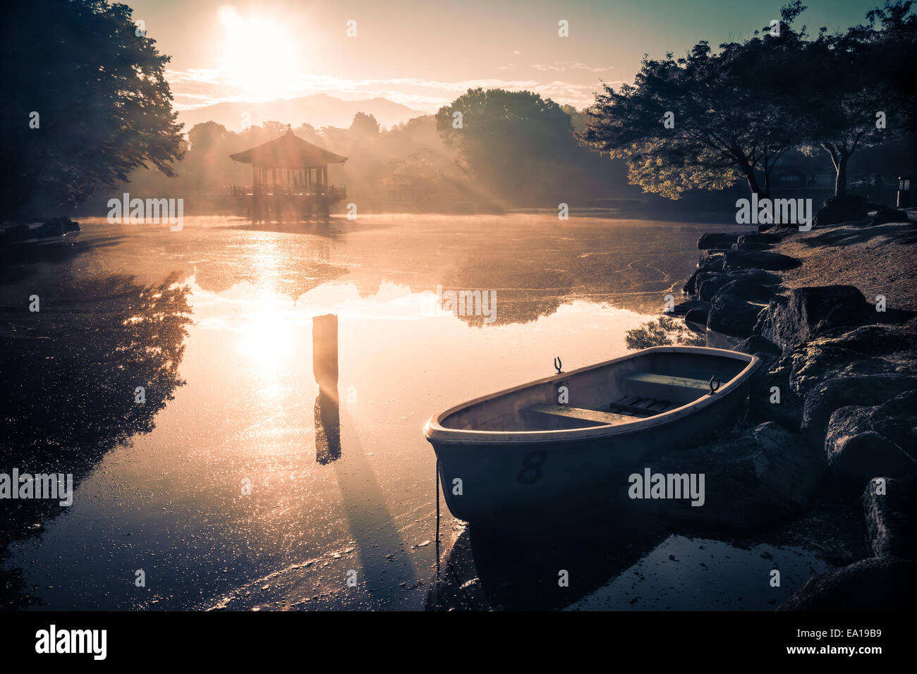 Sepia landscape of a boat on a pond in Japan at sunrise. Rowing boat on ...