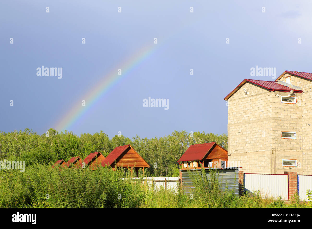 Beautiful rainbow over the houses Stock Photo - Alamy