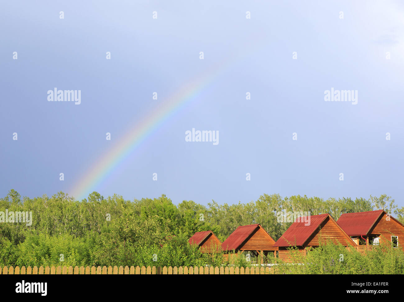 Beautiful rainbow over the houses Stock Photo - Alamy