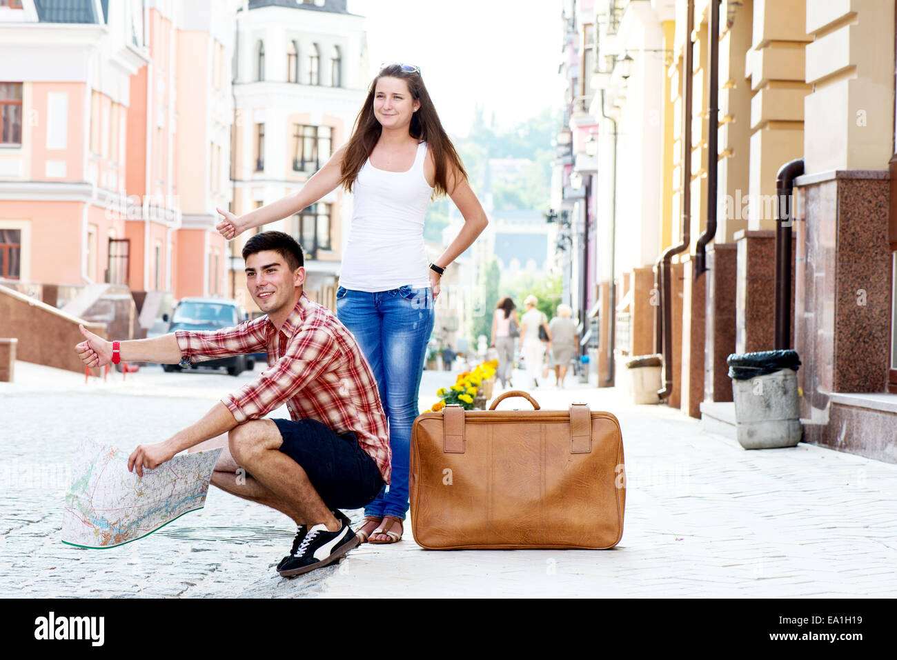 Young couple hitchhiking Stock Photo - Alamy