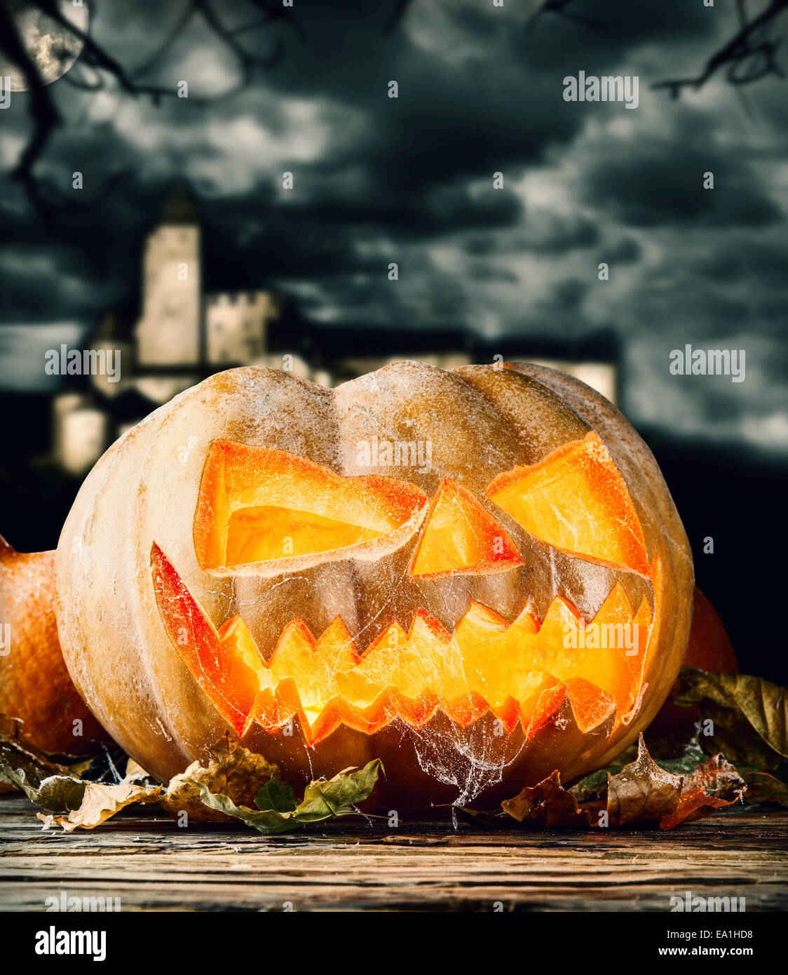 Concept of halloween pumpkin on wooden planks. Blur scary castle on ...