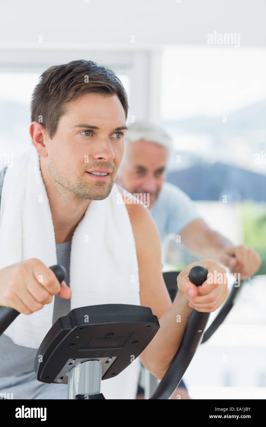 Man exercising on fitness bike Stock Photo - Alamy