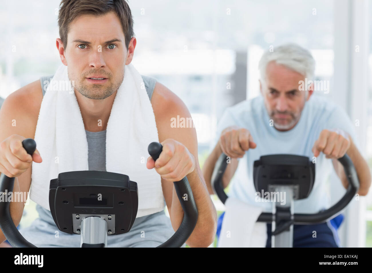 Handsome man using exercise bike Stock Photo - Alamy