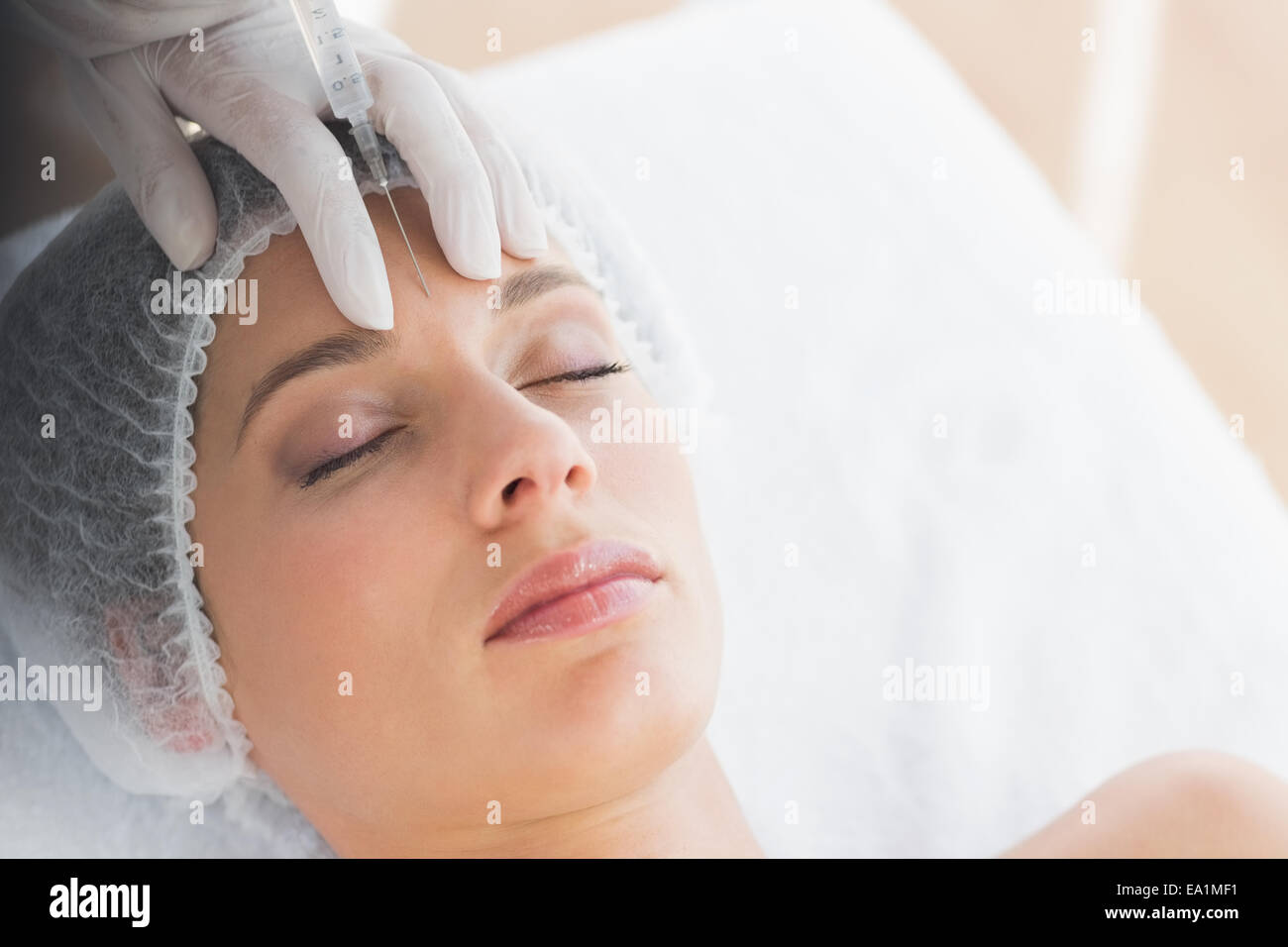 Woman recieving botox injection in forehead Stock Photo - Alamy