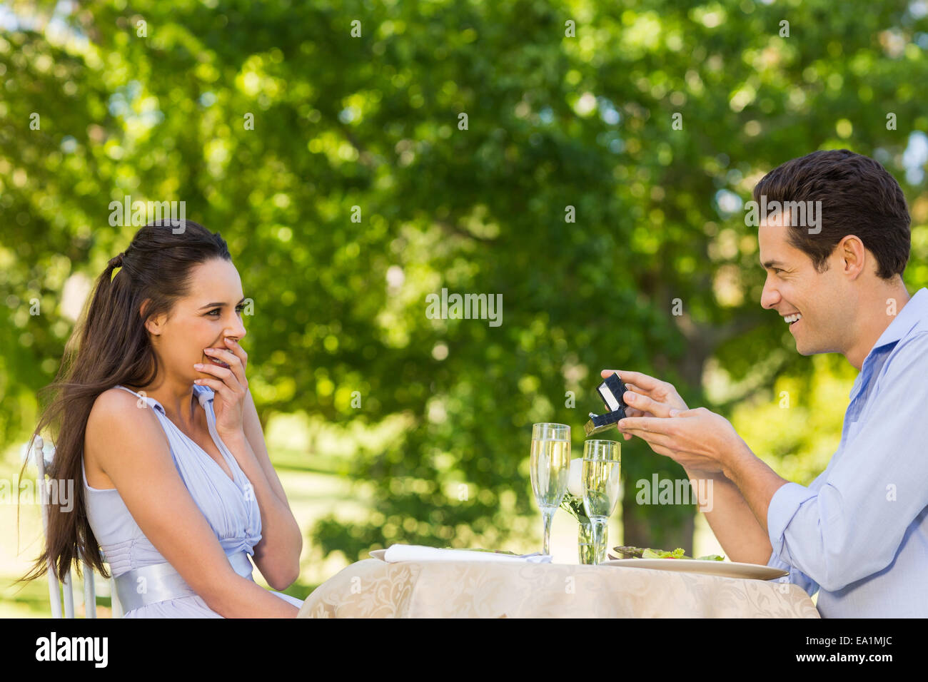 Man proposing woman at an outdoor café Stock Photo - Alamy