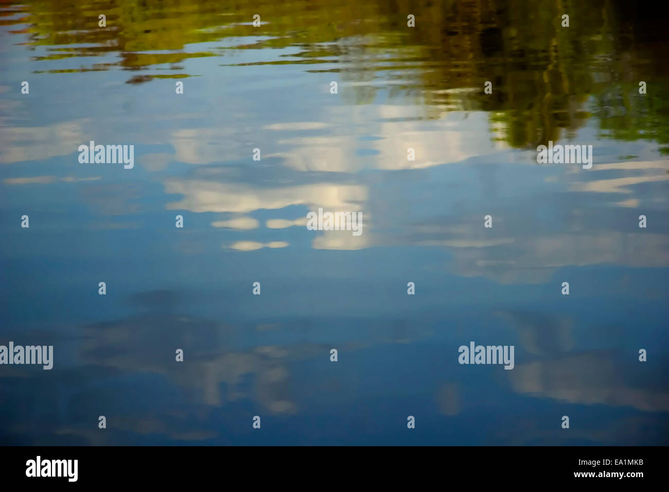 Sky reflected in a wavy water surface Stock Photo - Alamy