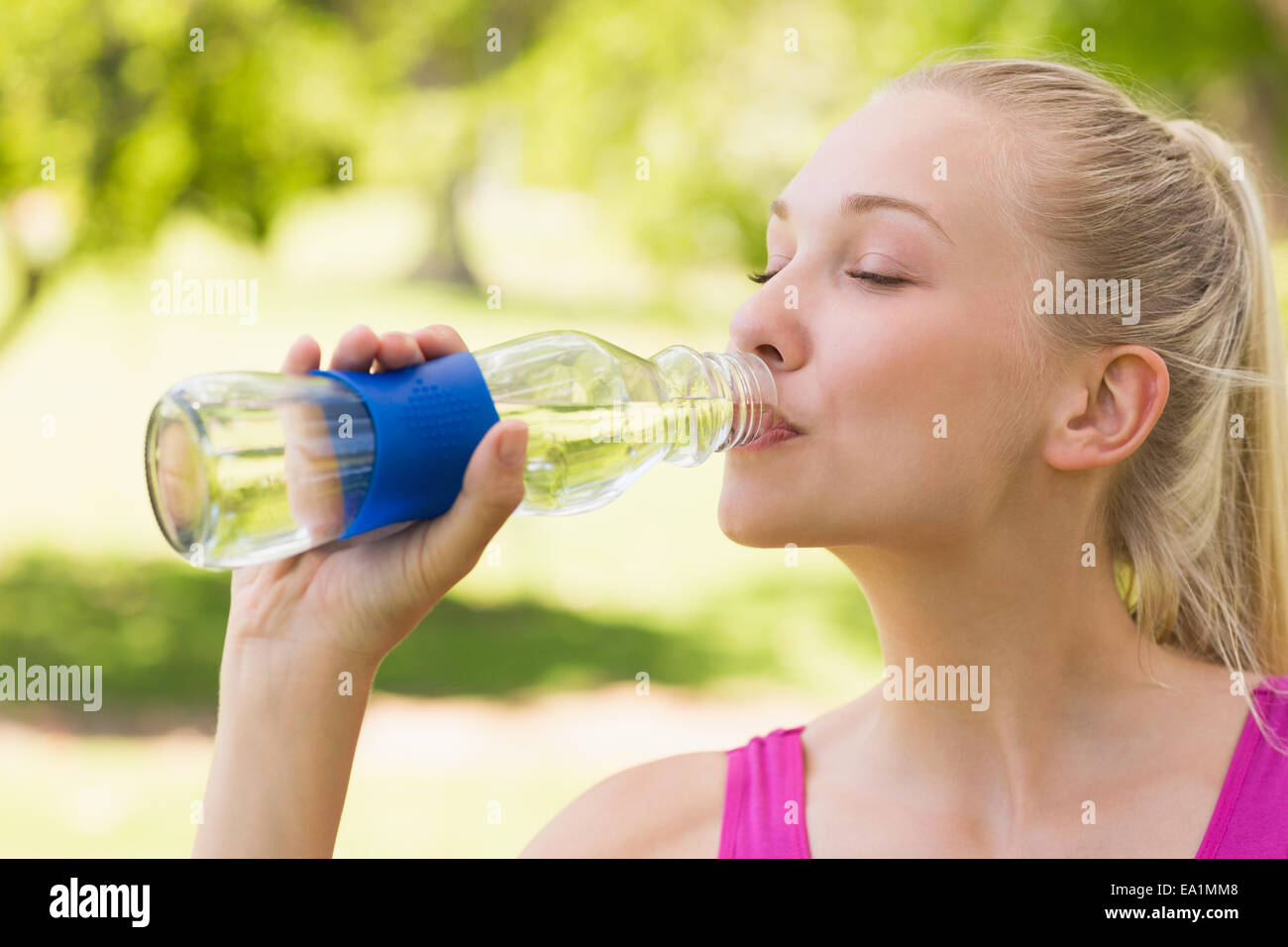 Close-up of a woman drinking water in park Stock Photo - Alamy