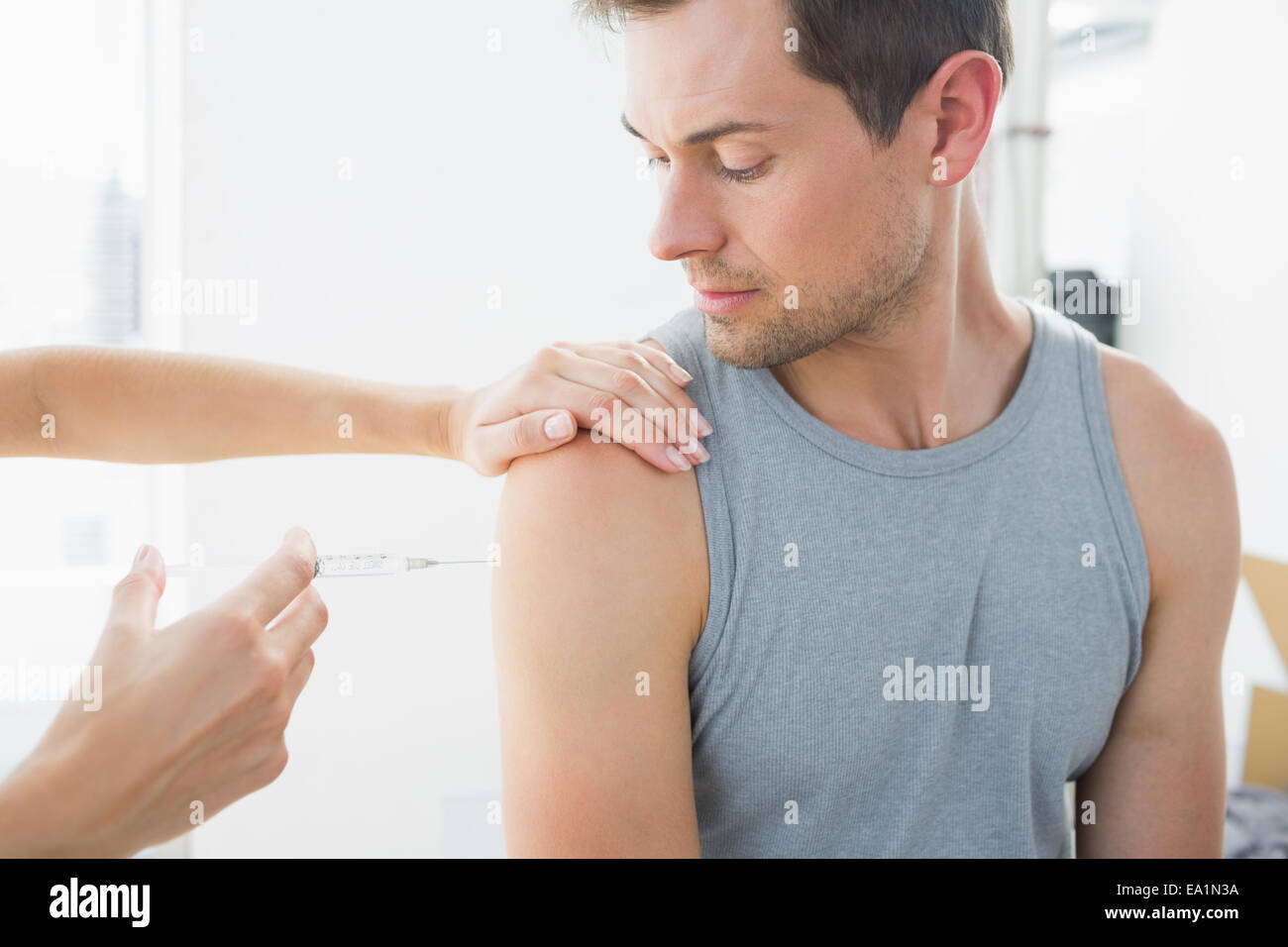 Doctor injecting man on arm in hospital Stock Photo - Alamy