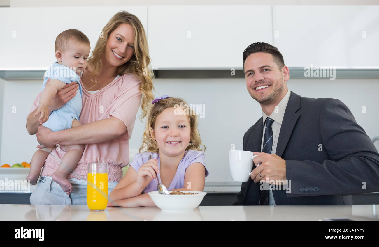 Happy family at table in house Stock Photo - Alamy