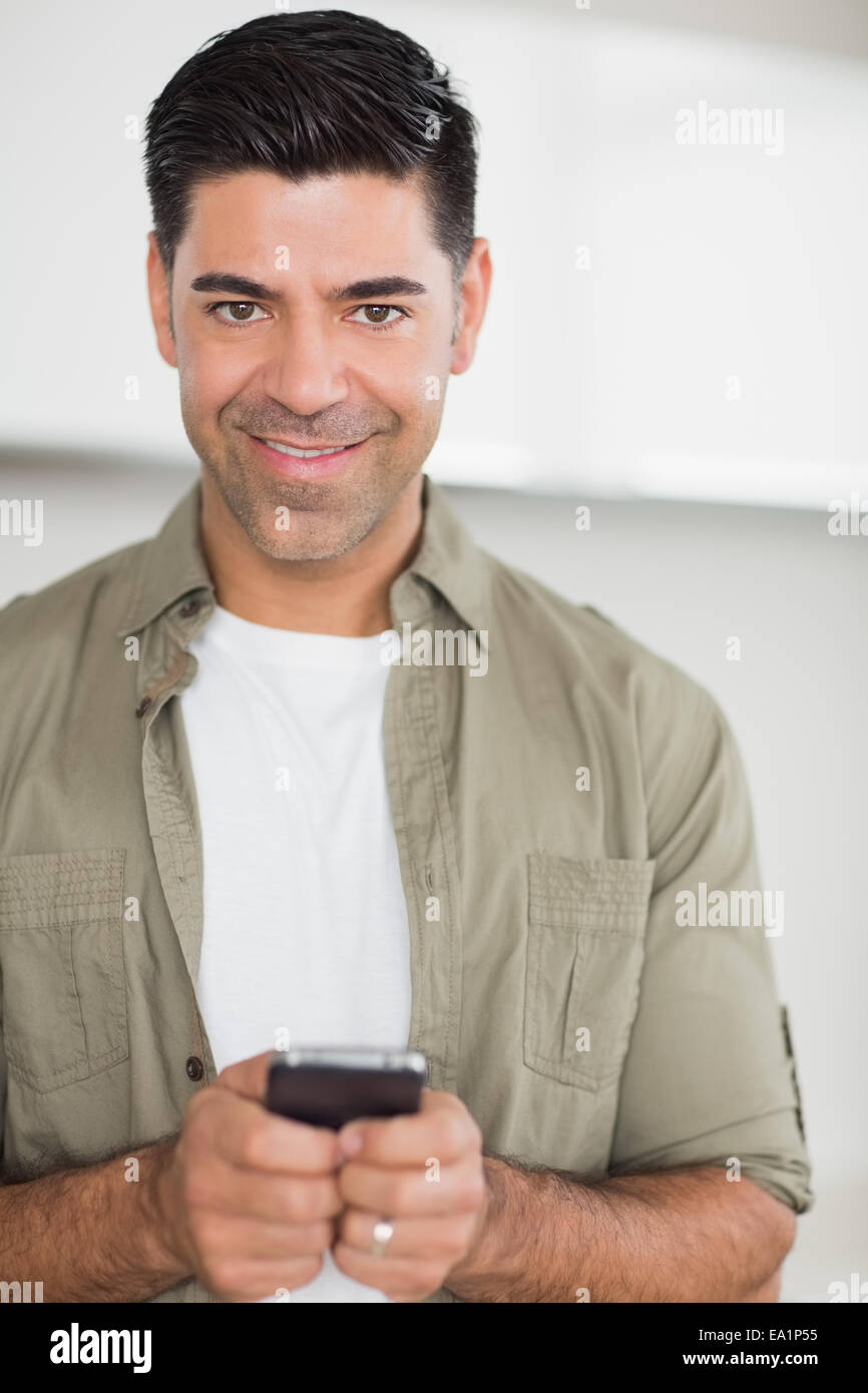 Smiling man text messaging Stock Photo - Alamy
