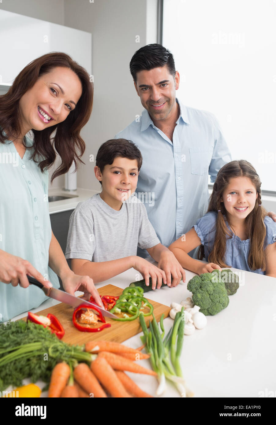 Family chopping vegetables in the kitchen Stock Photo - Alamy