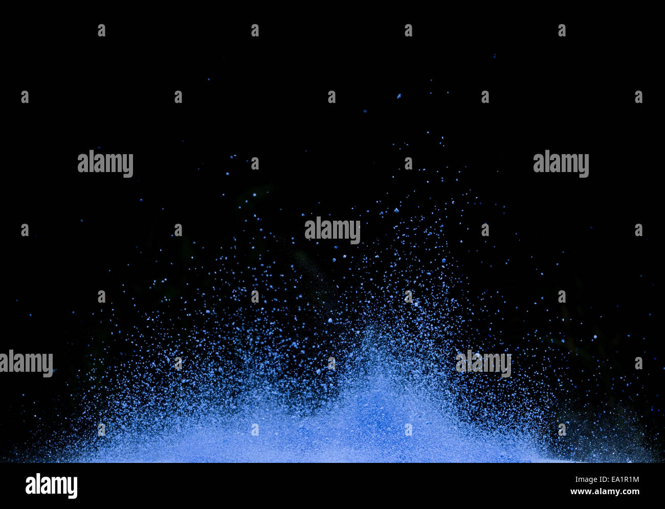 Freeze motion of blue dust explosion isolated on black background Stock ...