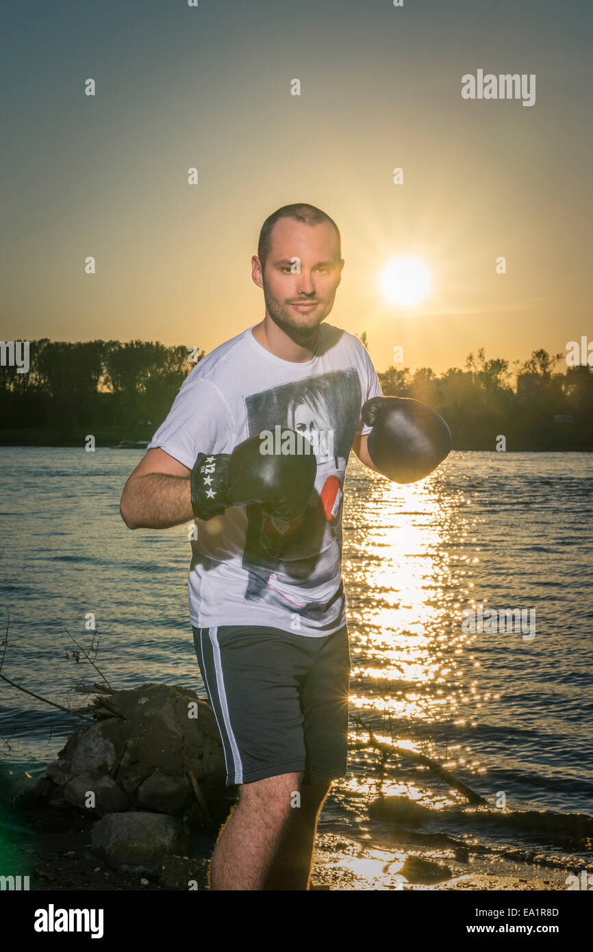 Men with boxing gloves at a river Stock Photo - Alamy