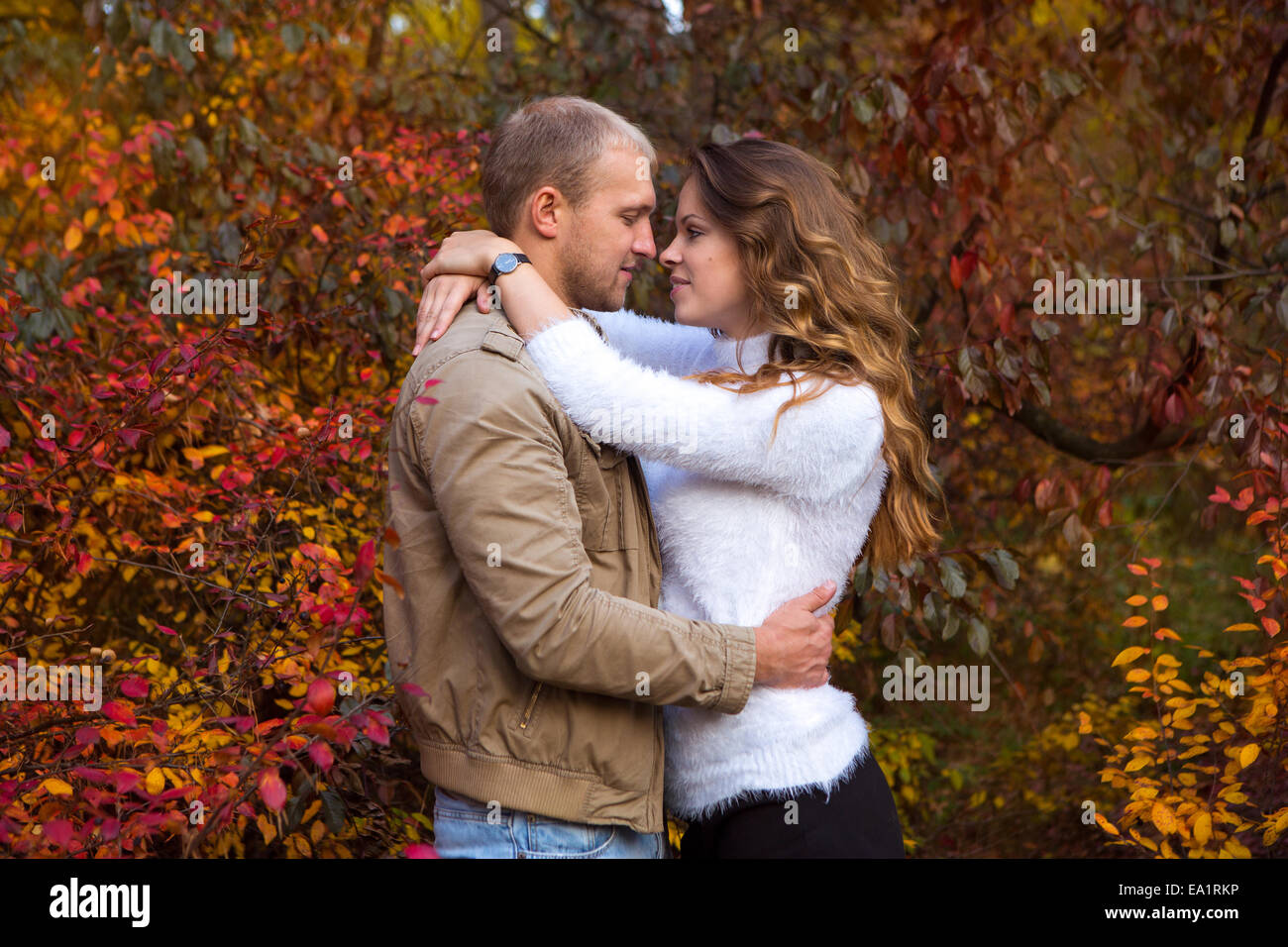 Beautiful young couple walking in autumn Park Stock Photo - Alamy
