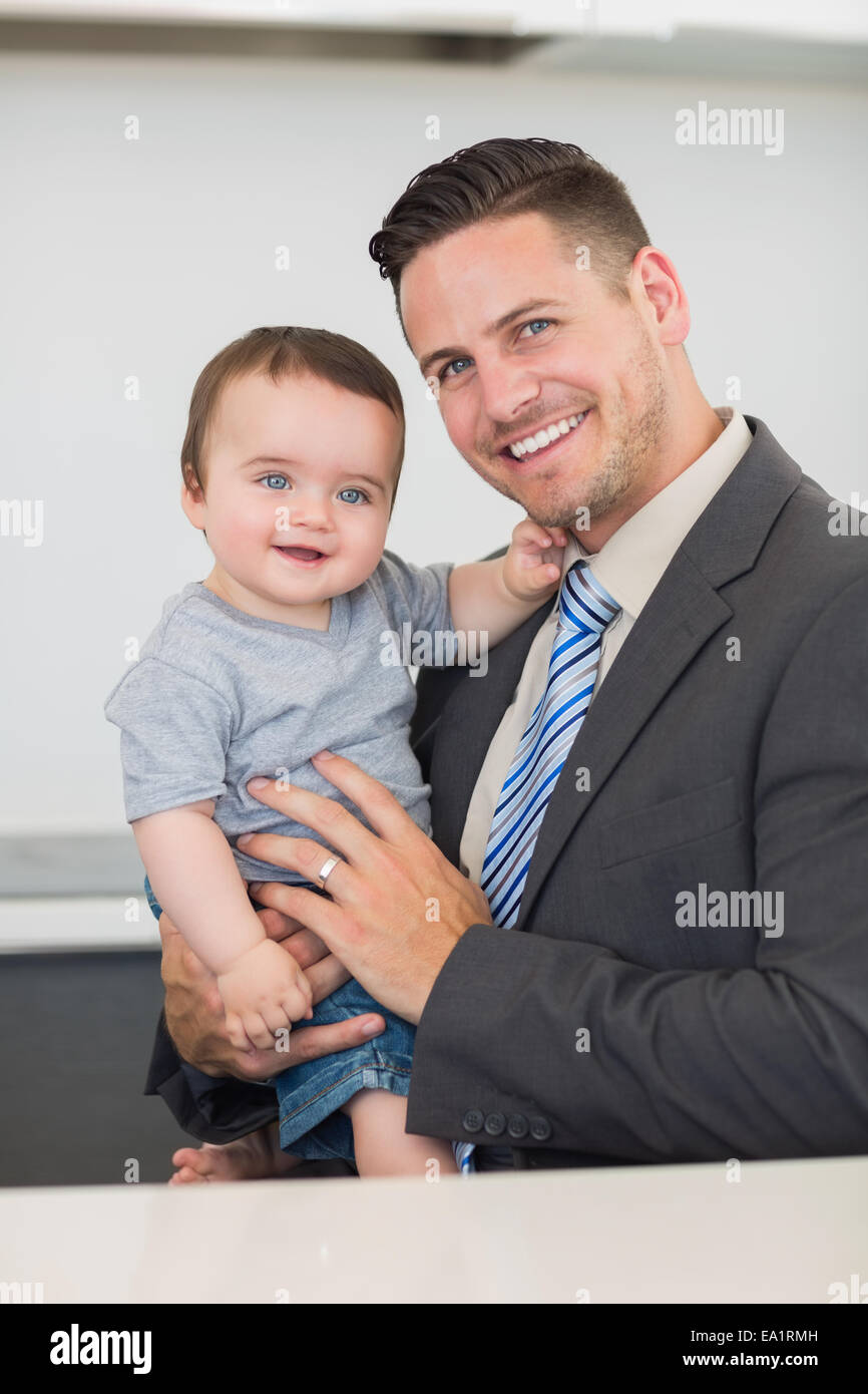 Happy businessman carrying baby boy Stock Photo - Alamy