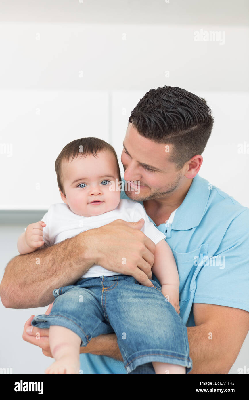 Loving father carrying baby Stock Photo - Alamy