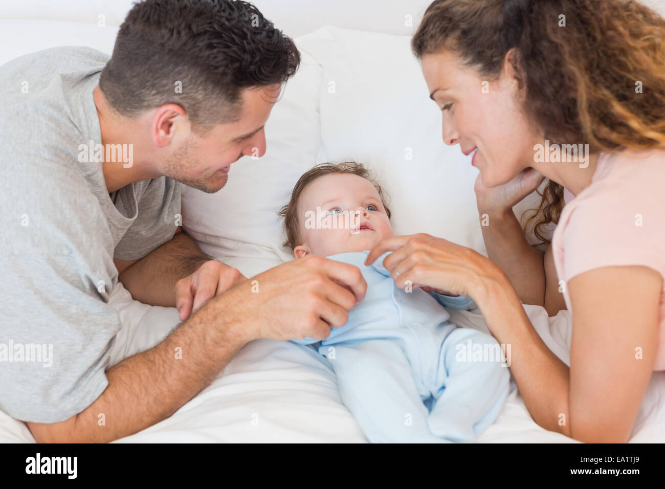 Happy parents playing with baby boy Stock Photo - Alamy