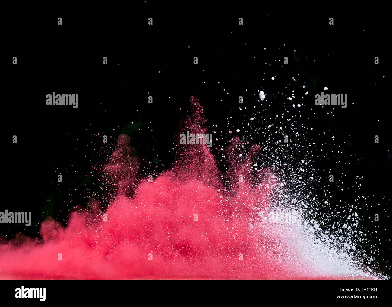 Freeze motion of red dust explosion isolated on black background Stock ...