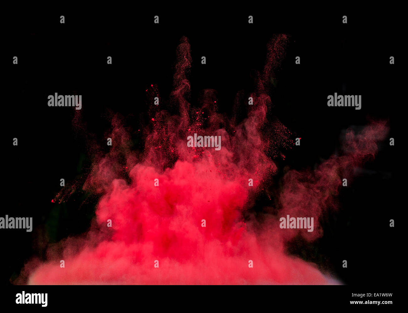 Freeze motion of red dust explosion isolated on black background Stock ...