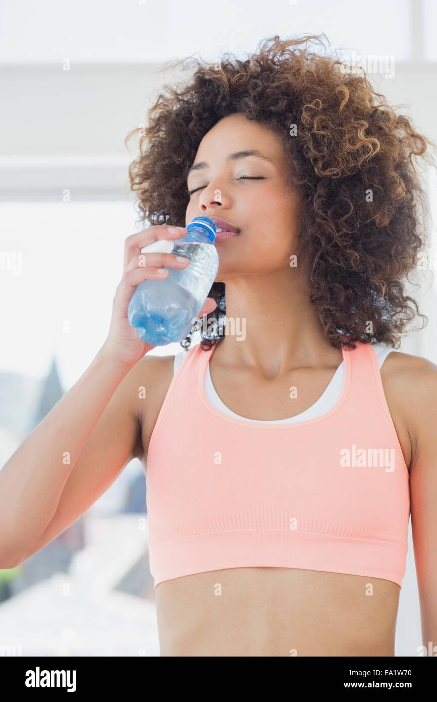 Fit female drinking water at gym Stock Photo - Alamy