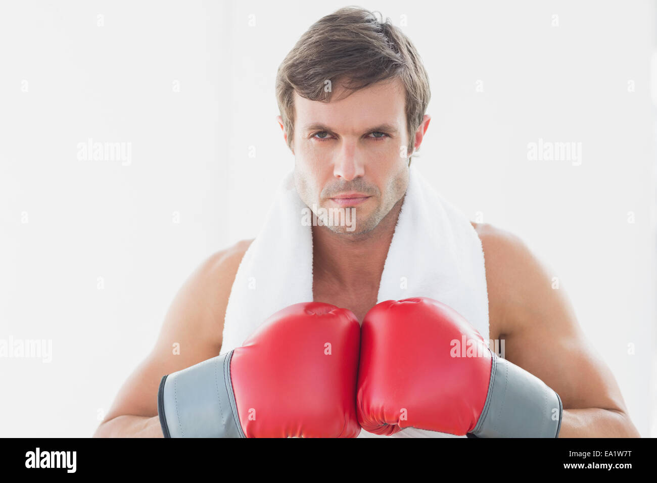 Serious young man in red boxing gloves Stock Photo - Alamy