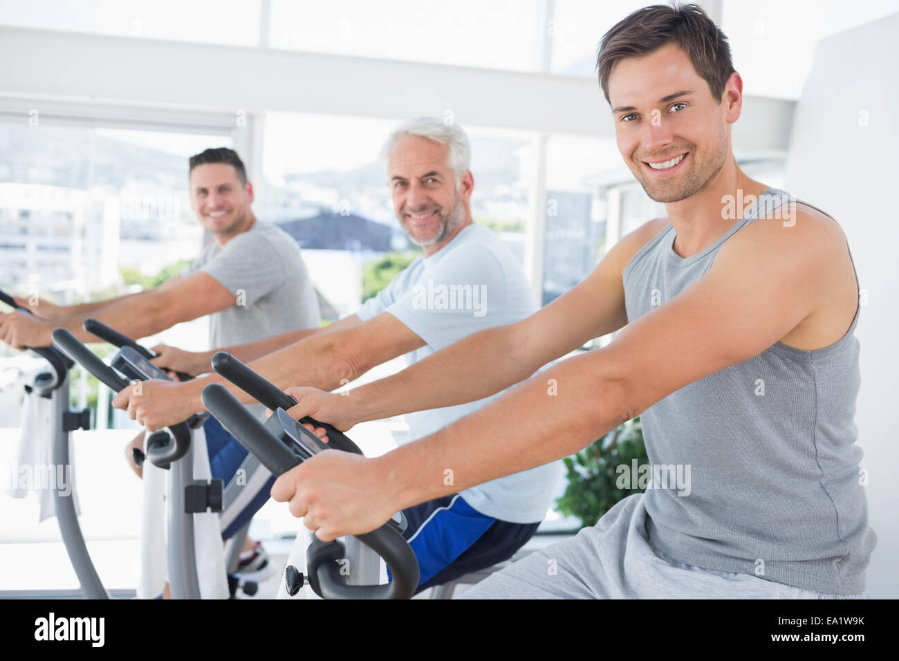 Men on exercise bikes Stock Photo - Alamy