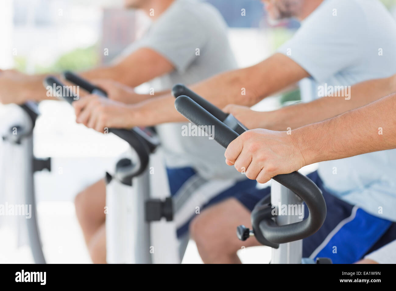 Men using exercise bikes Stock Photo - Alamy