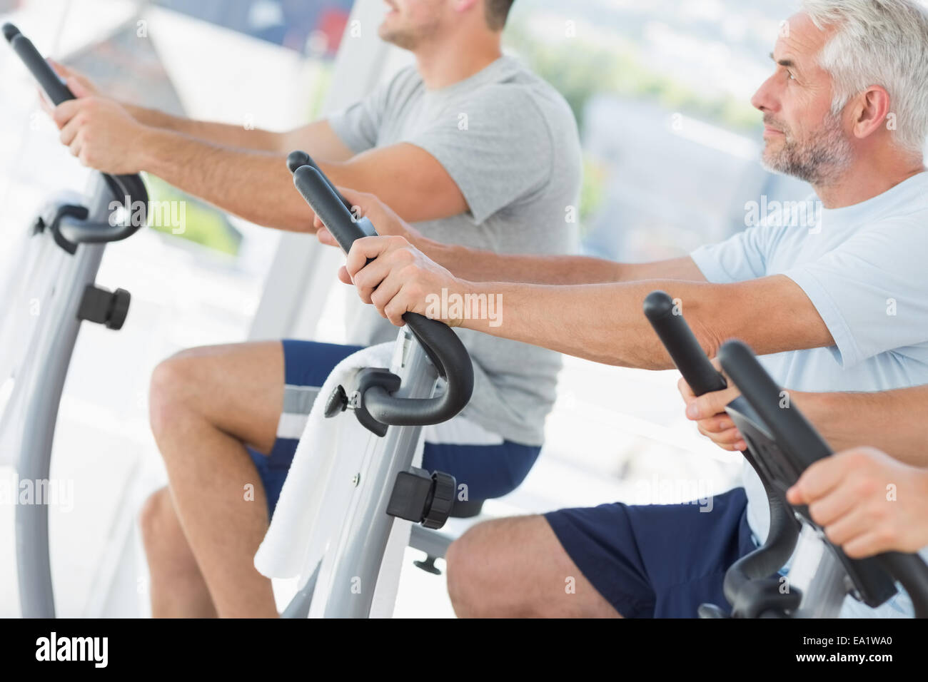 Men using exercise bikes Stock Photo - Alamy