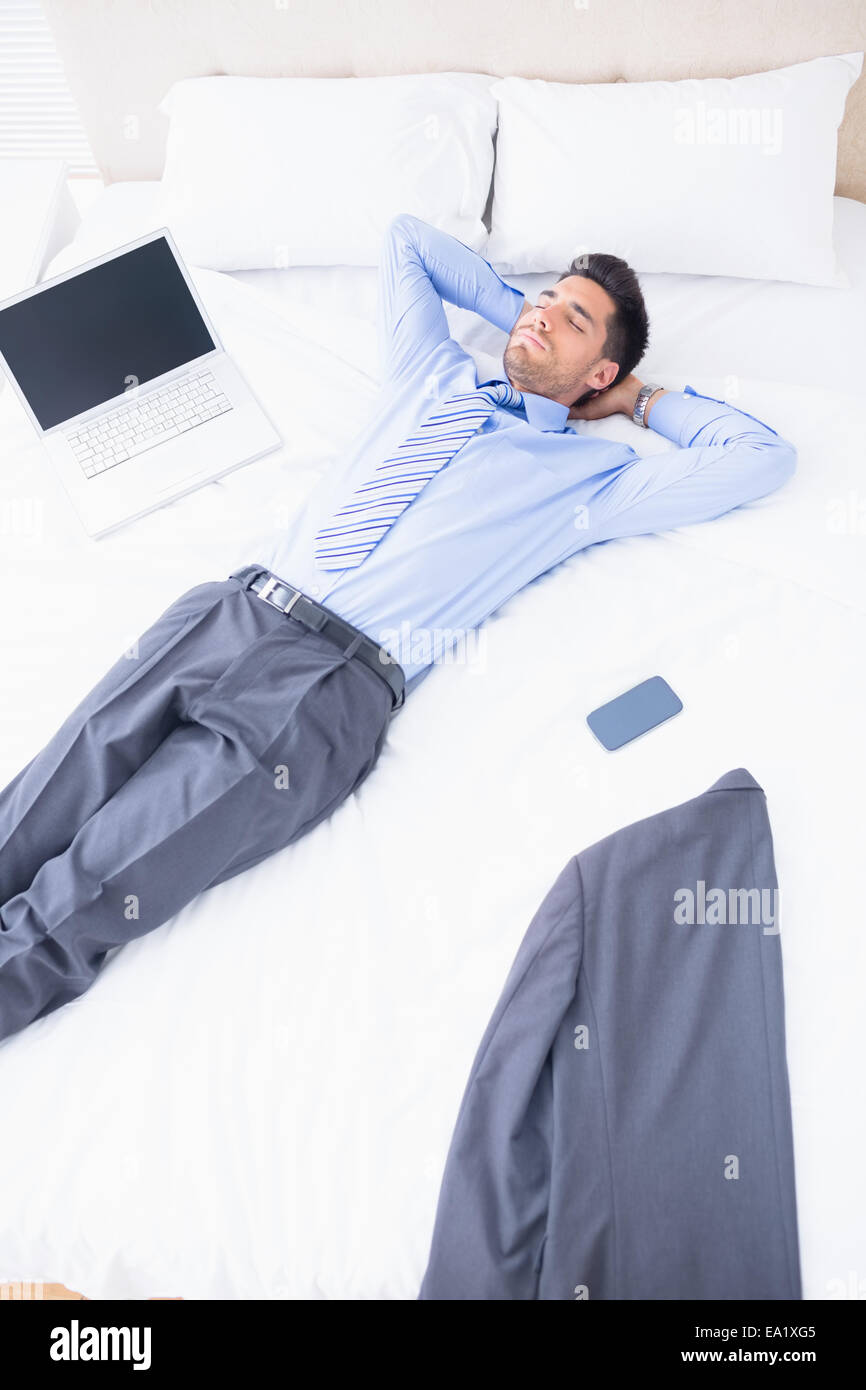 Napping businessman lying on his bed Stock Photo - Alamy
