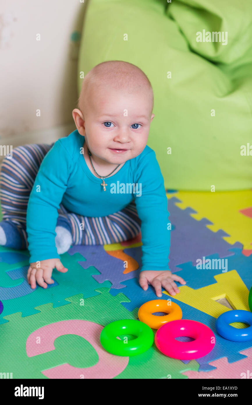 Cute little baby playing with colorful toys at home Stock Photo - Alamy