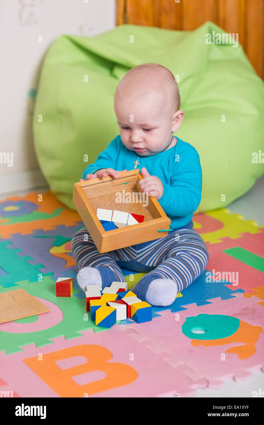 Cute little baby playing with colorful toys at home Stock Photo - Alamy